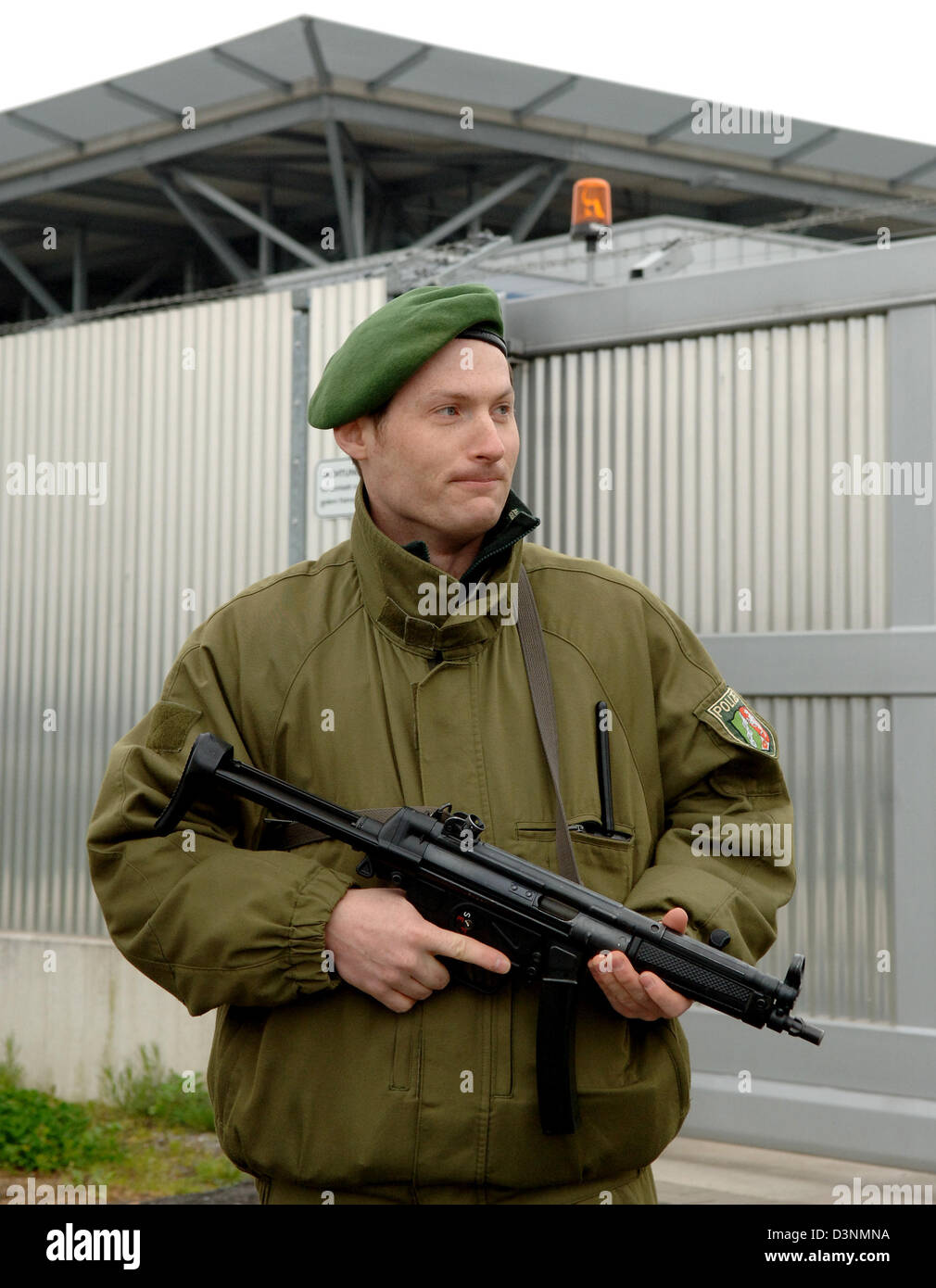 A police officer with a machine gun guards the entrance to Higher ...