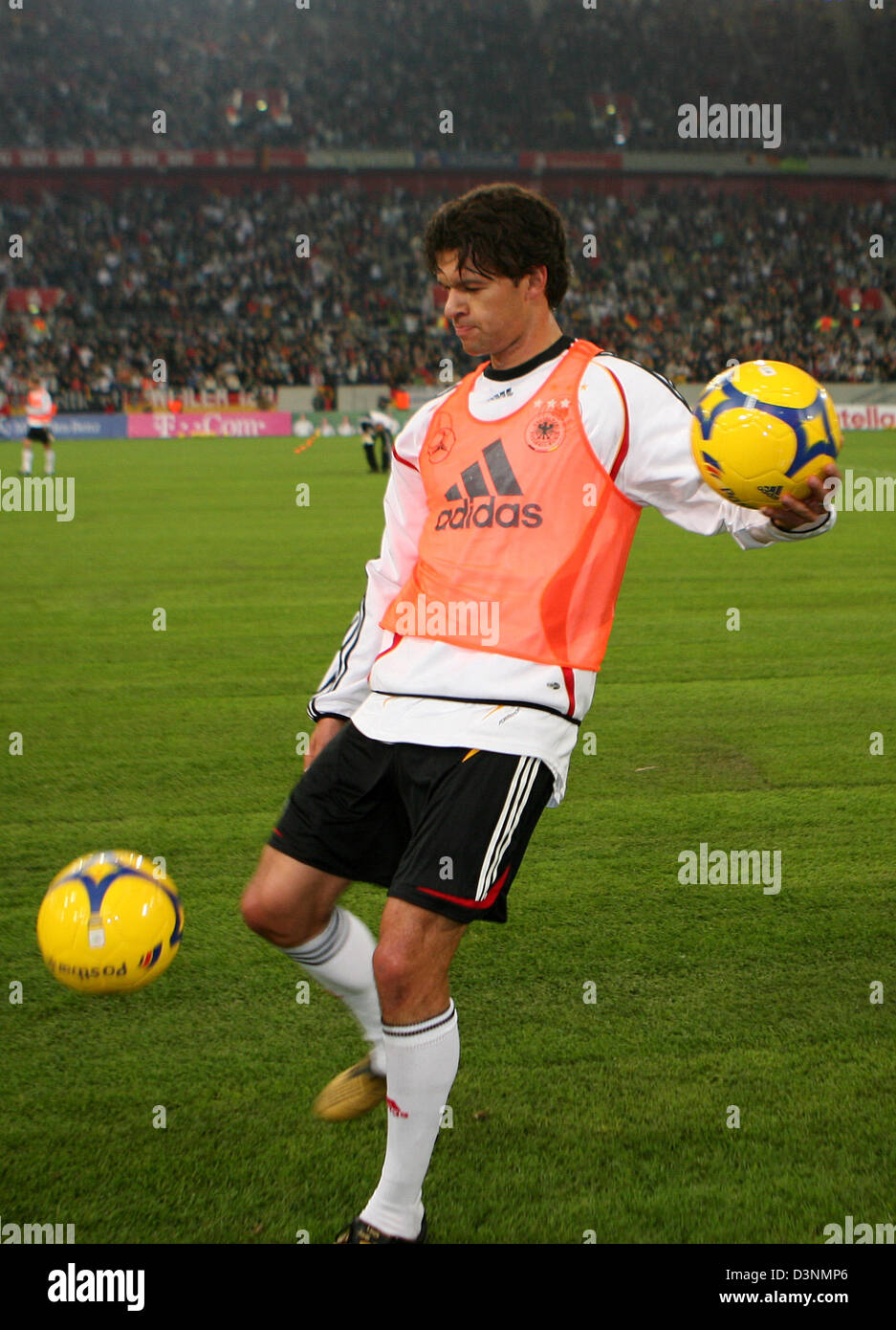 German national player Michael Ballack throws balls to the spectators ...