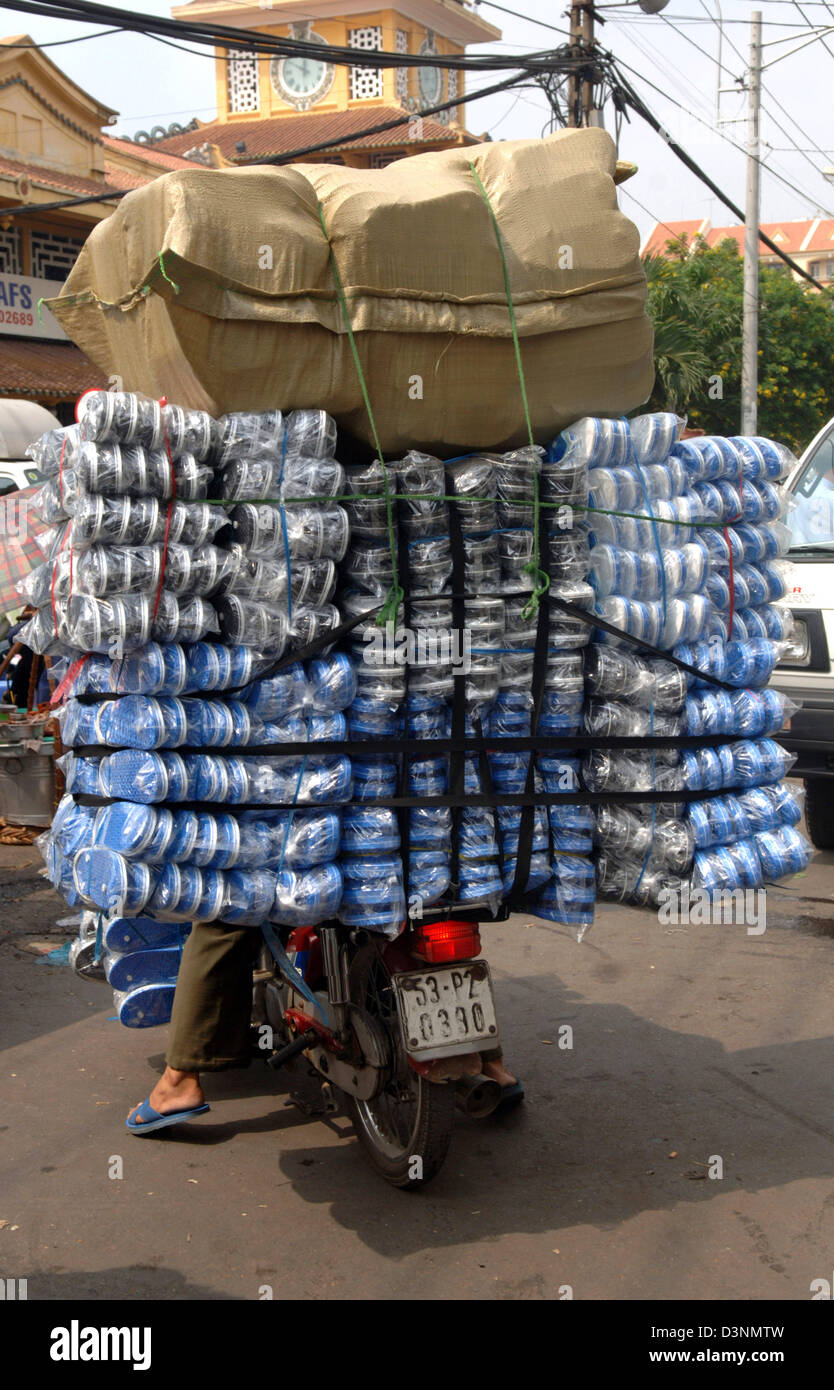 A merchant parks his moped loaded with shoes in Saigon, Vietnam, 27 ...