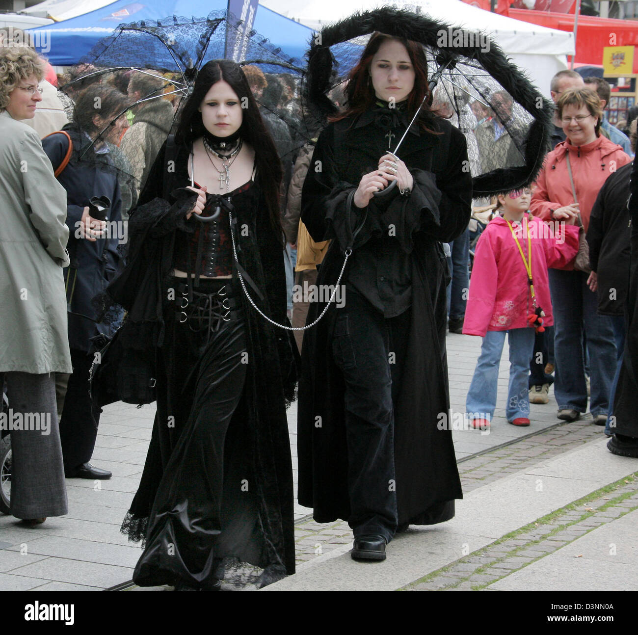 Two visitors of the 15th Wave Gothic Meeting walk through the city ...