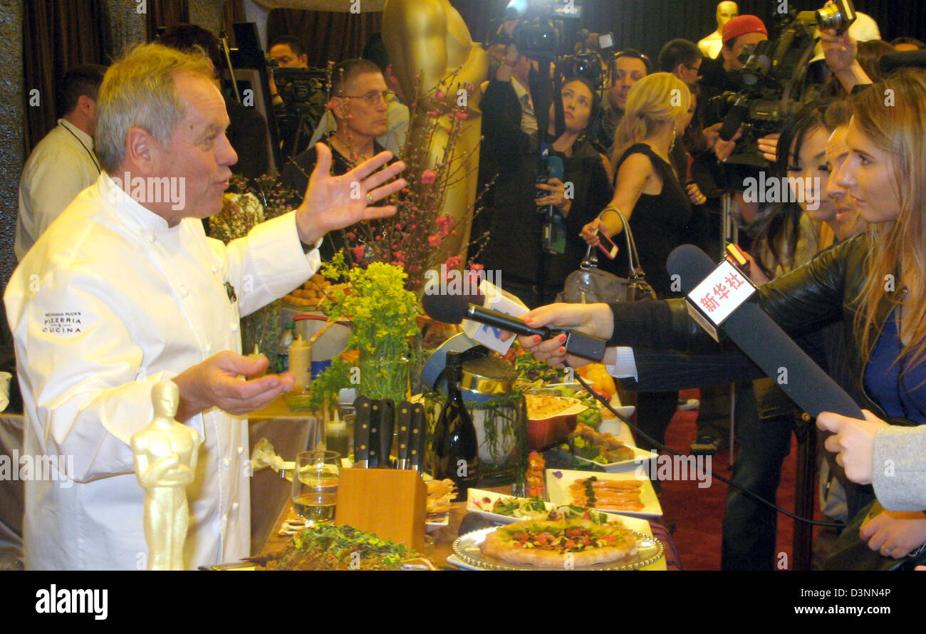 Austrian celebrity chef Wolfgang Puck (L) gives an interview on his ...