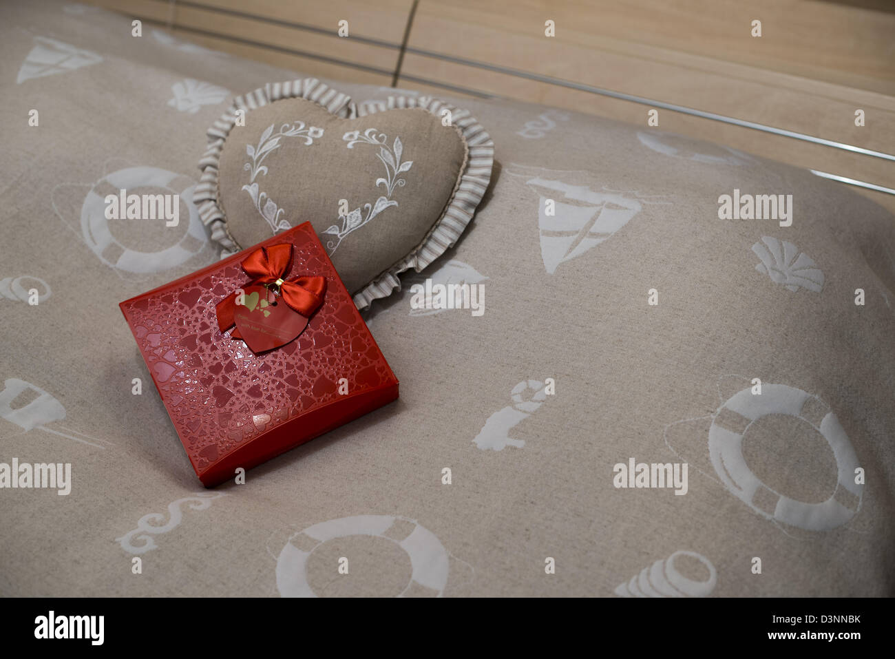 red present box with heart shapes on the bed Stock Photo - Alamy
