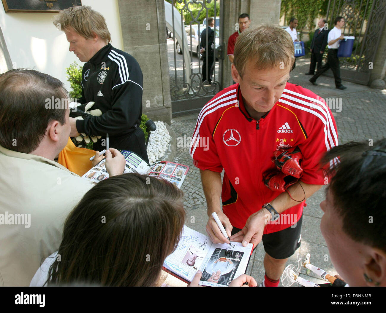 German national coach Juergen Klinsmann signs autographs for the ...