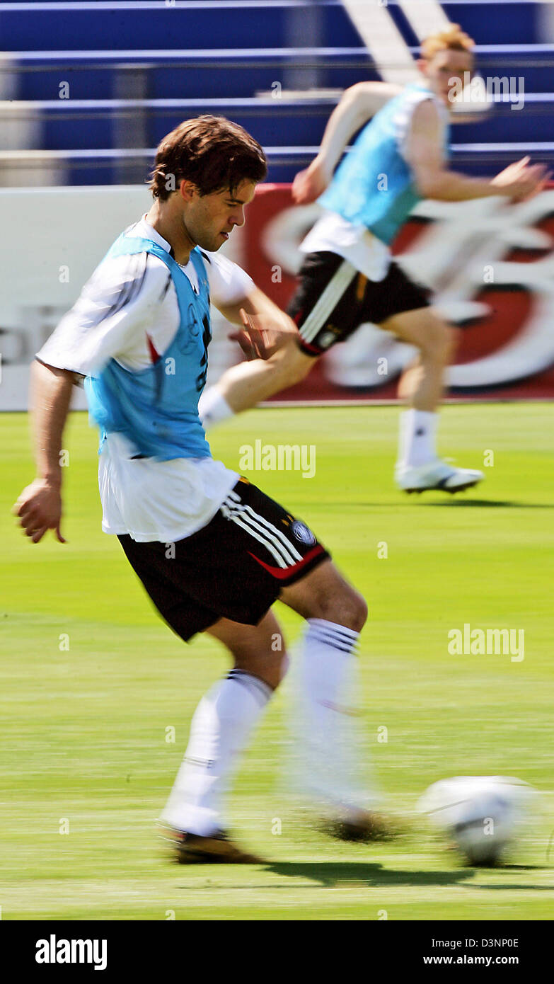 German players Michael Ballack (L) and Bastian Schweinsteiger run ...