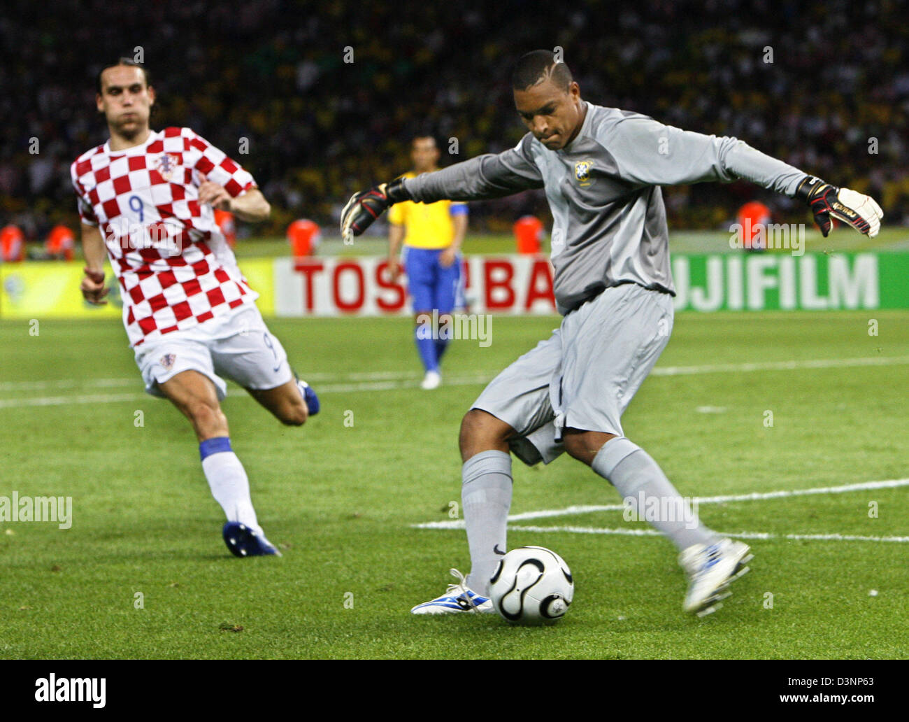 Brazilian goalkeeper Dida (R) clears the ball in front of Croatia's ...