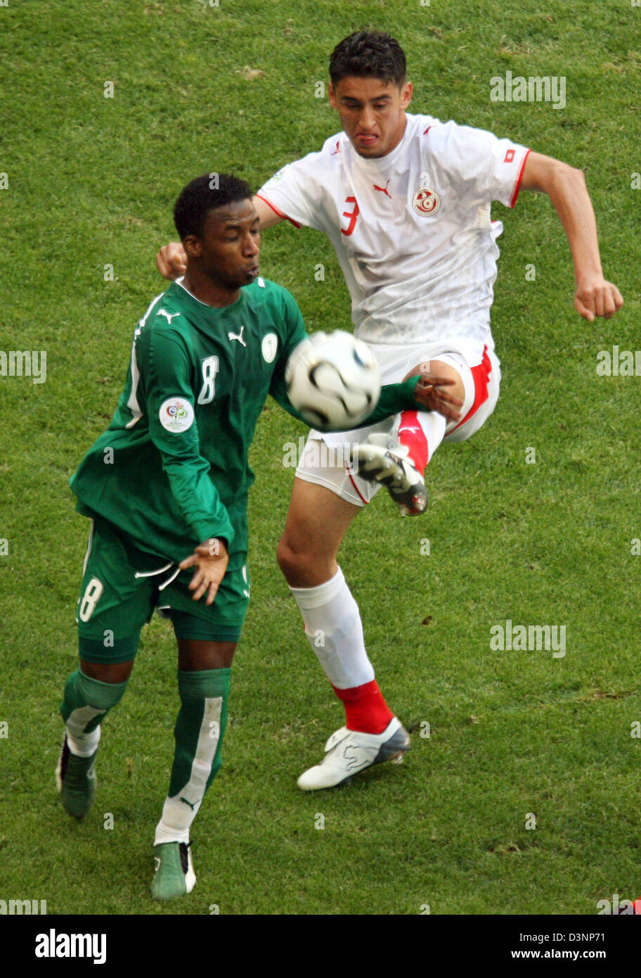 Tunisian Karim Haggui (R) fights for the ball with Mohammed Noor of ...