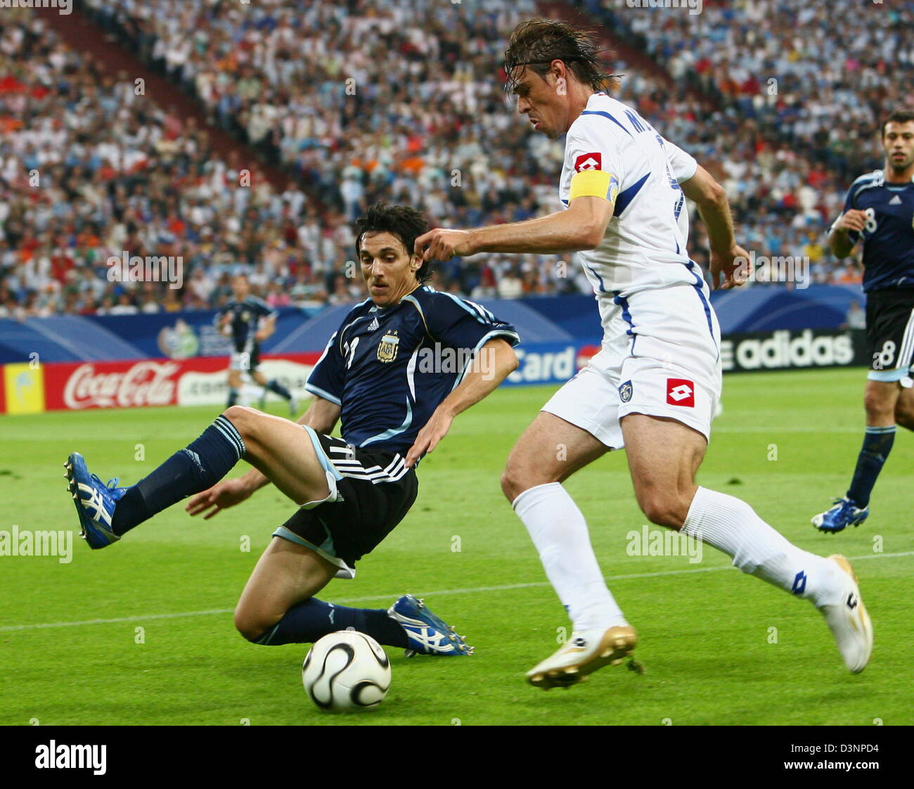 Nicolas Burdisso (L) from Argentina tries to block the cross Savo ...
