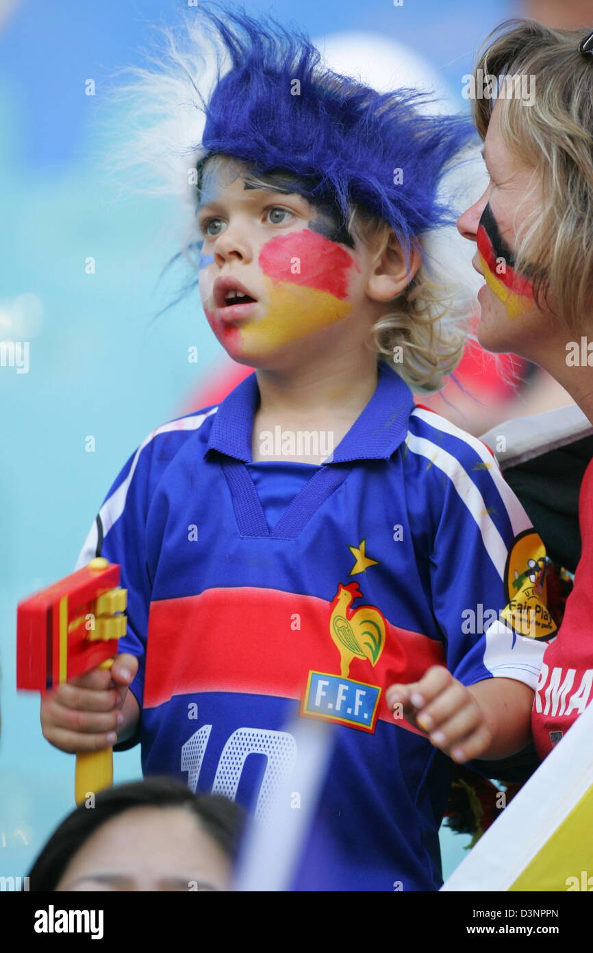 A small boy wearing a jersey of the French national soccer team is ...