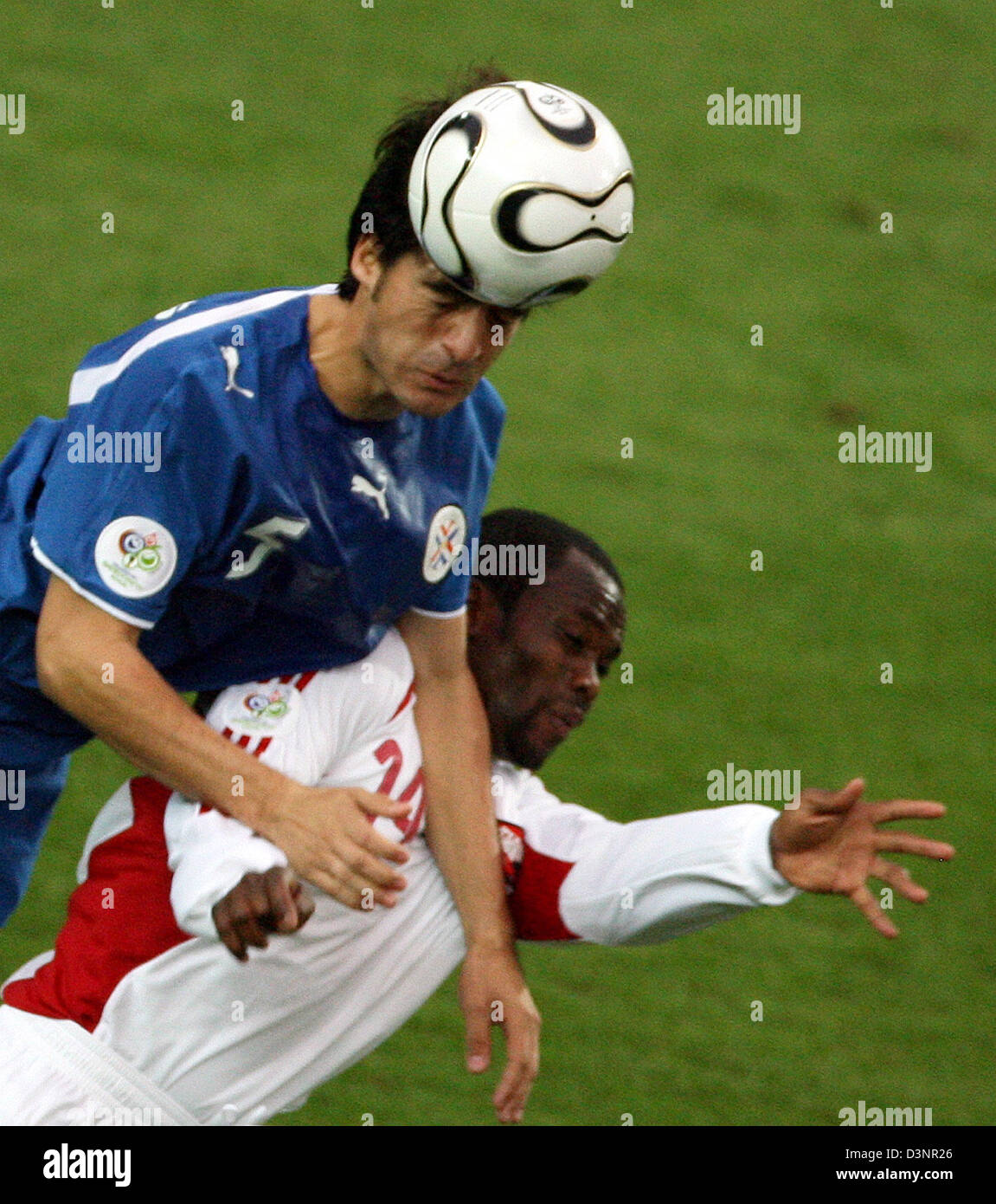 Julio Cesar Caceres (L) from Paraguay vies with Stern John (R) from ...