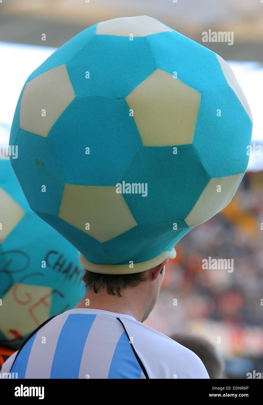 A supporter of Argentina photographed with a soccer ball hat on his ...
