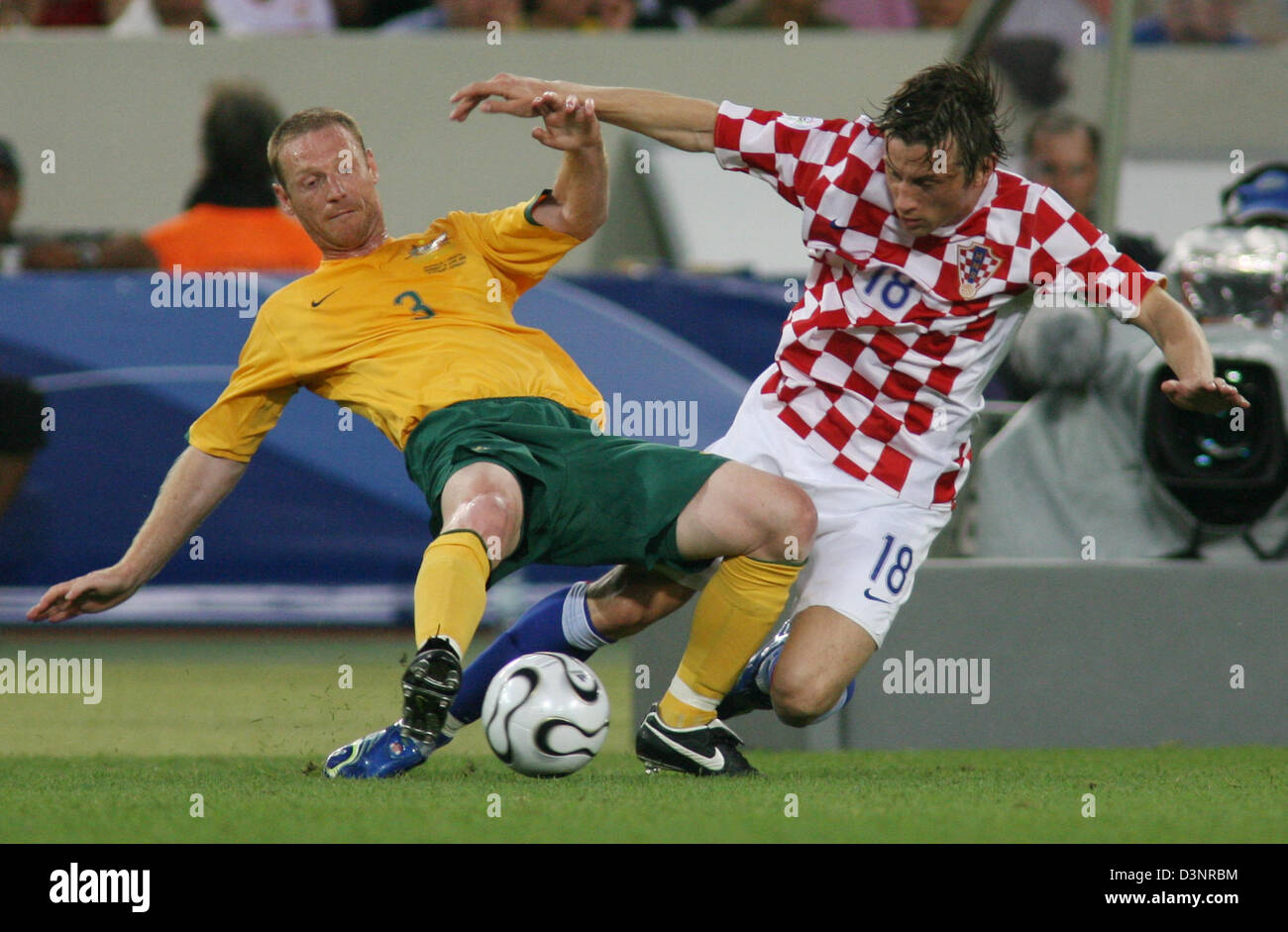 Ivica Olic (R) of Croatia and Craig Moore from Australia fight for the ...