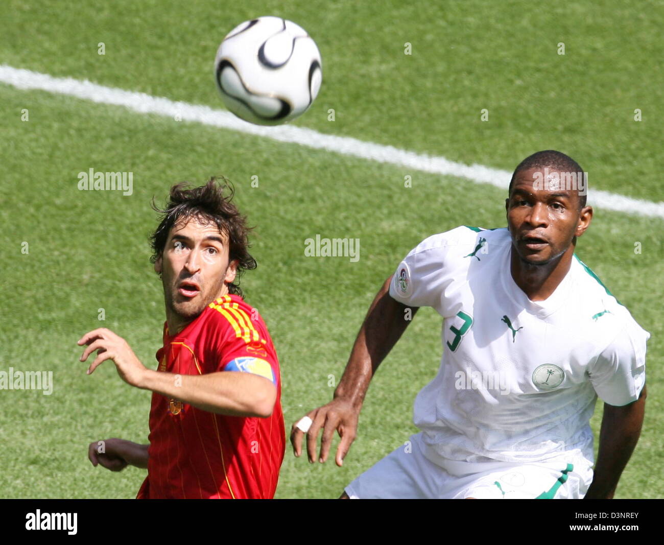 Raul (L) of Spain is about to play a heading duel with Redha Tukar of ...