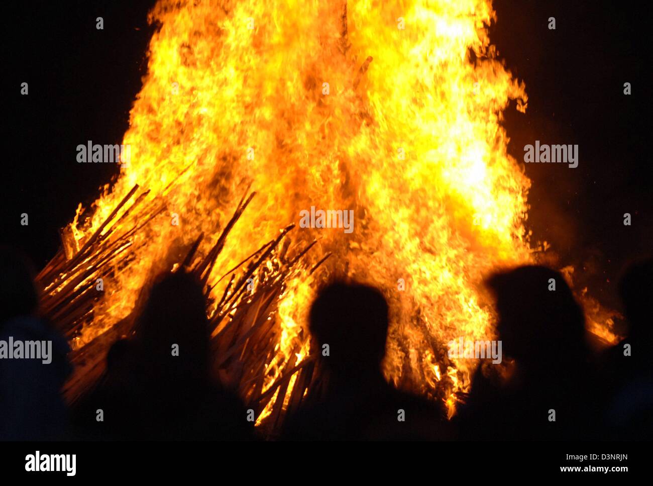 Visitors ot a John the Baprtist fire enjoy the fire on Wiesenfelden ...