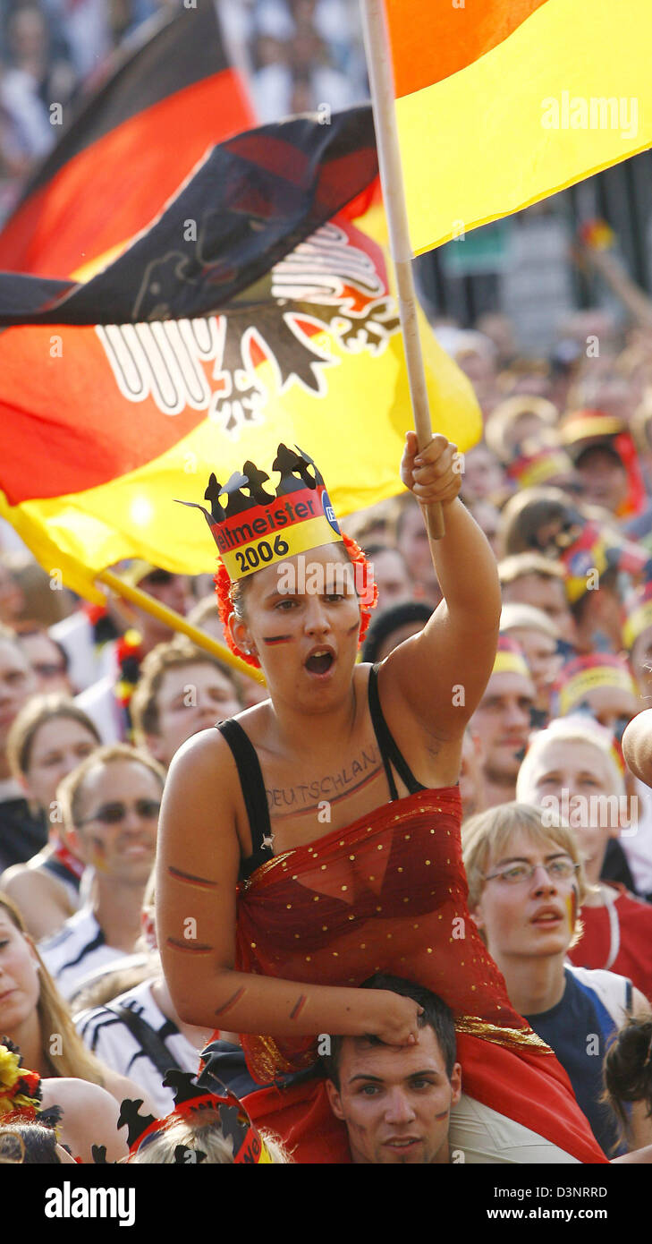 A female German supporter waves the German flag after Germany's victory ...