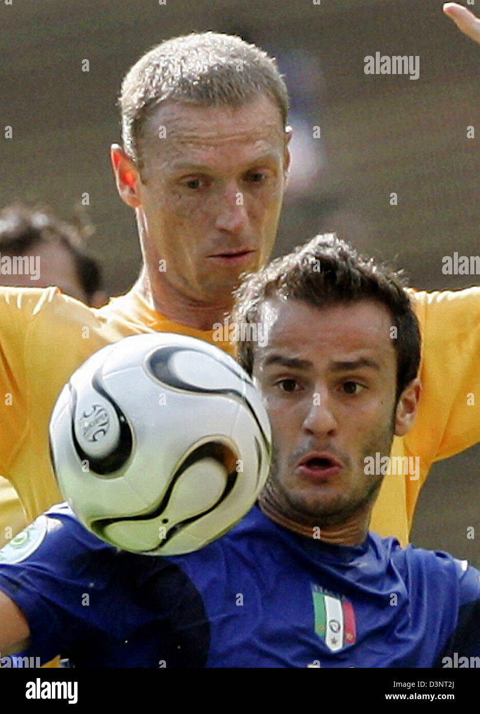 Craig Moore (L) of Australia vies with Alberto Gilardino of Italy ...