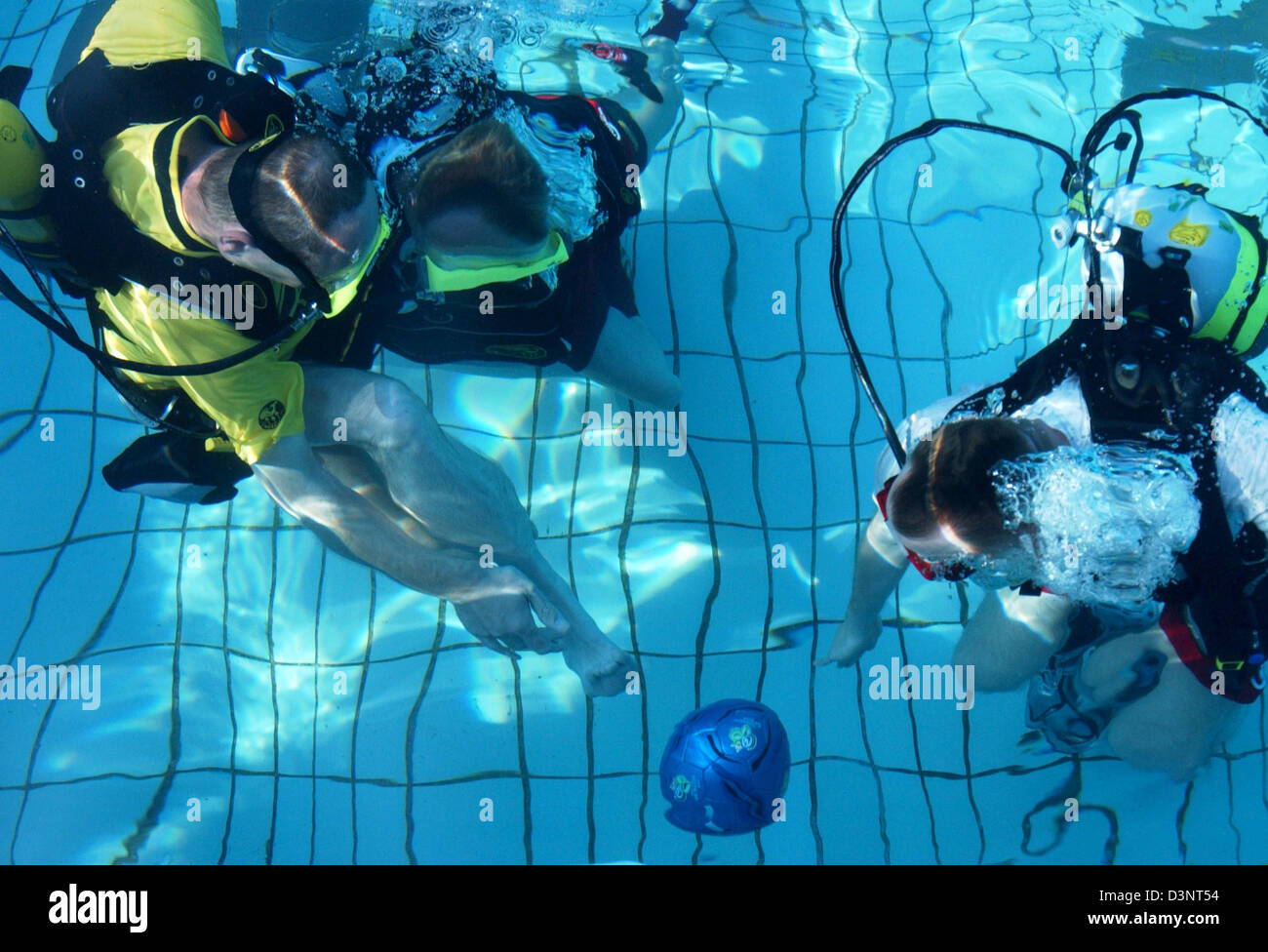 Three scuba divers vie for the ball during a match of the 1st German ...