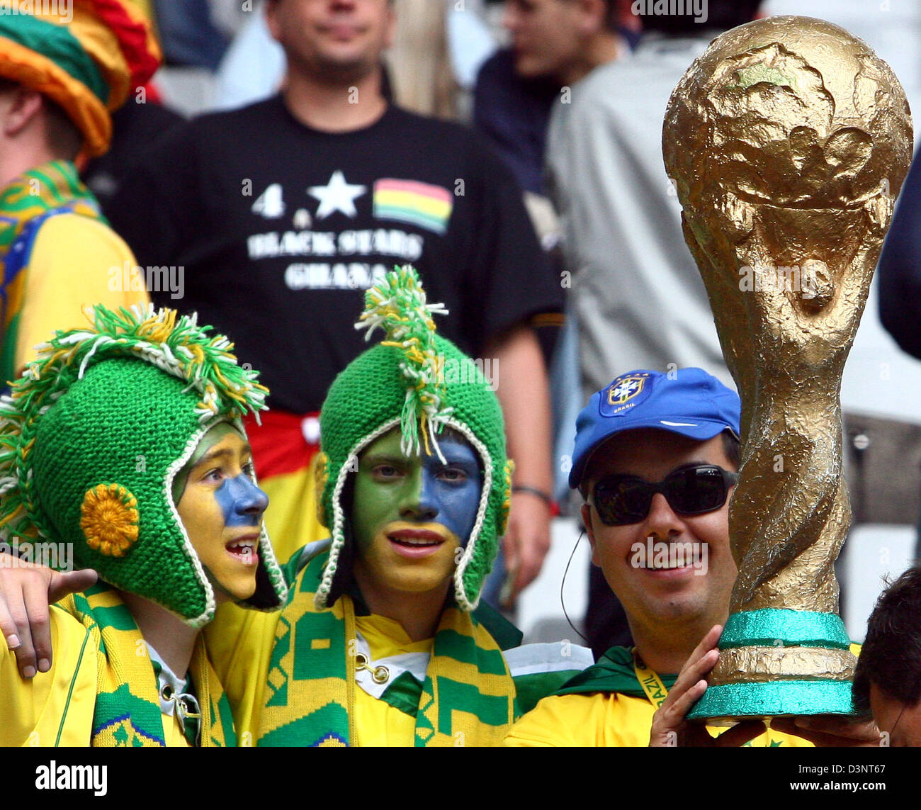 Supporters from Brazil show a repilca of the World Cup Trophy prior to ...