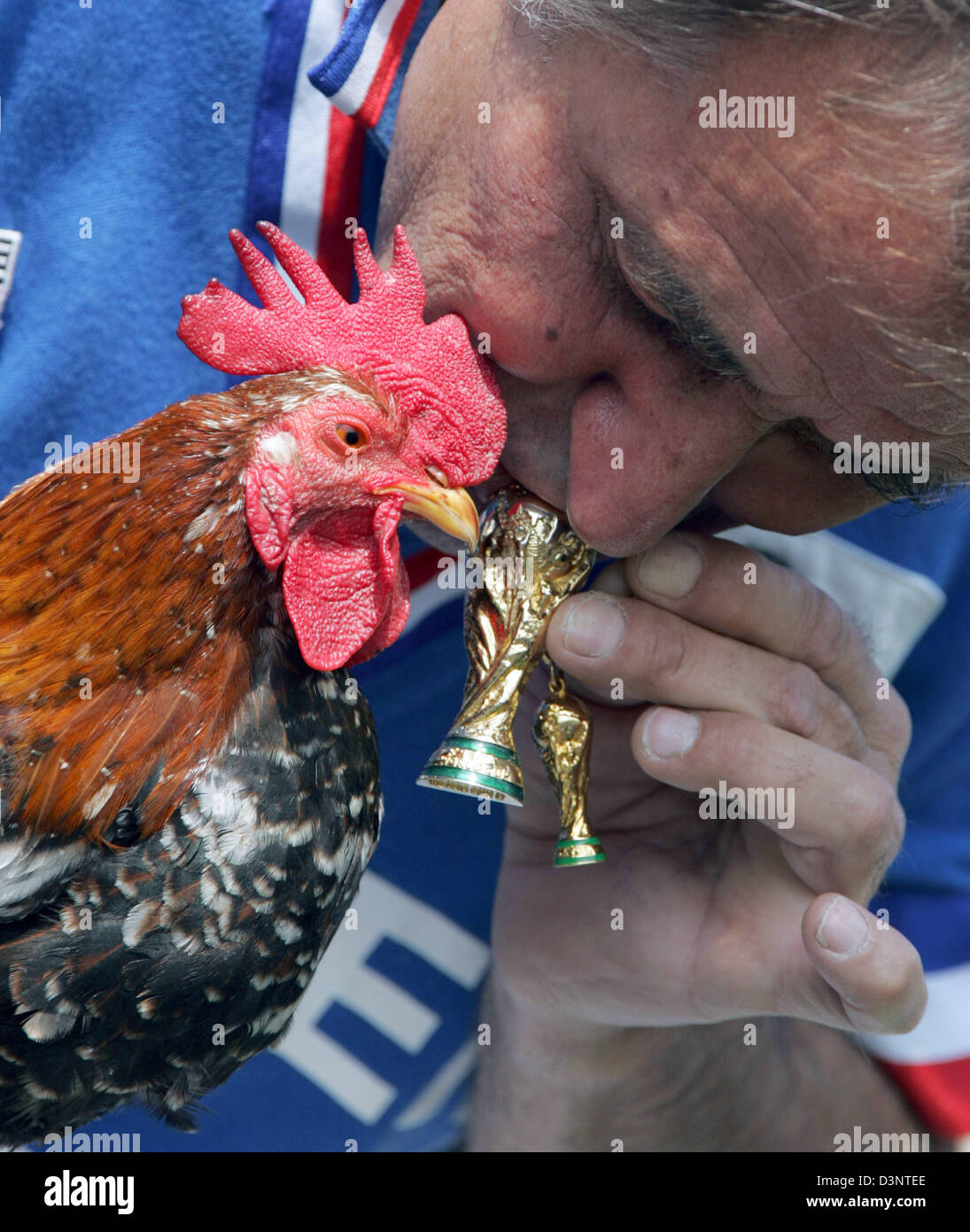 French supporter Clement d'Antibes kisses a miniature of the World Cup ...