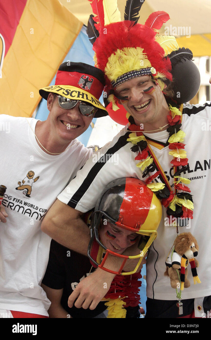 Three fans of the German national team pose during the fan party in ...