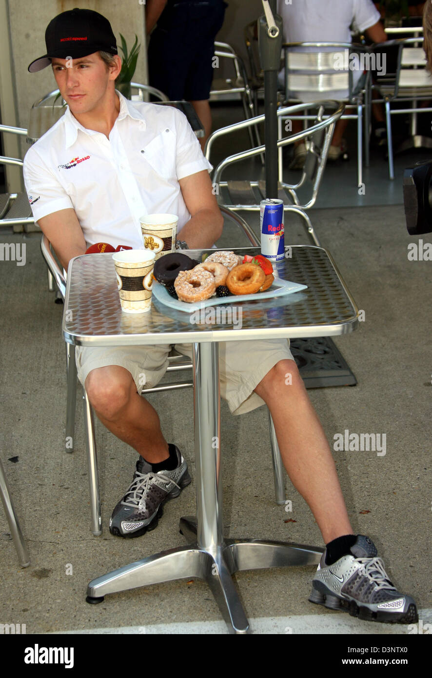 US Formula One pilot Scott Speed of the Toro Rosso team bites a snack ...