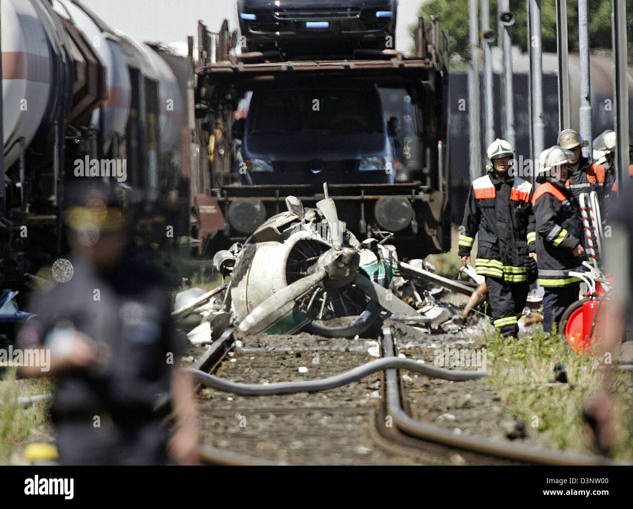 Policemen and fire brigade men safeguard the wreckage of a crashed ...