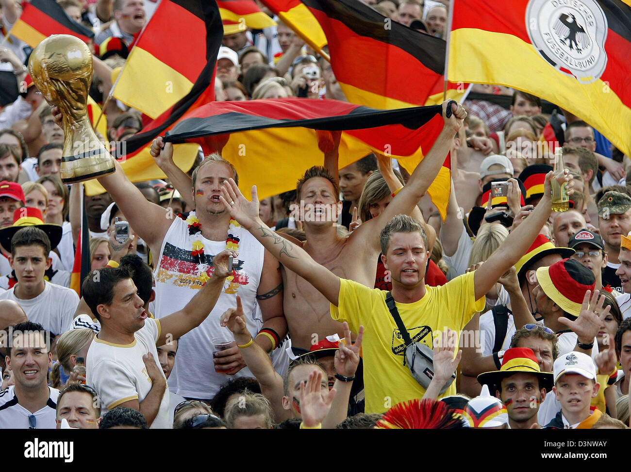Supporters of the German national team wave their flags on the Fan Fest ...