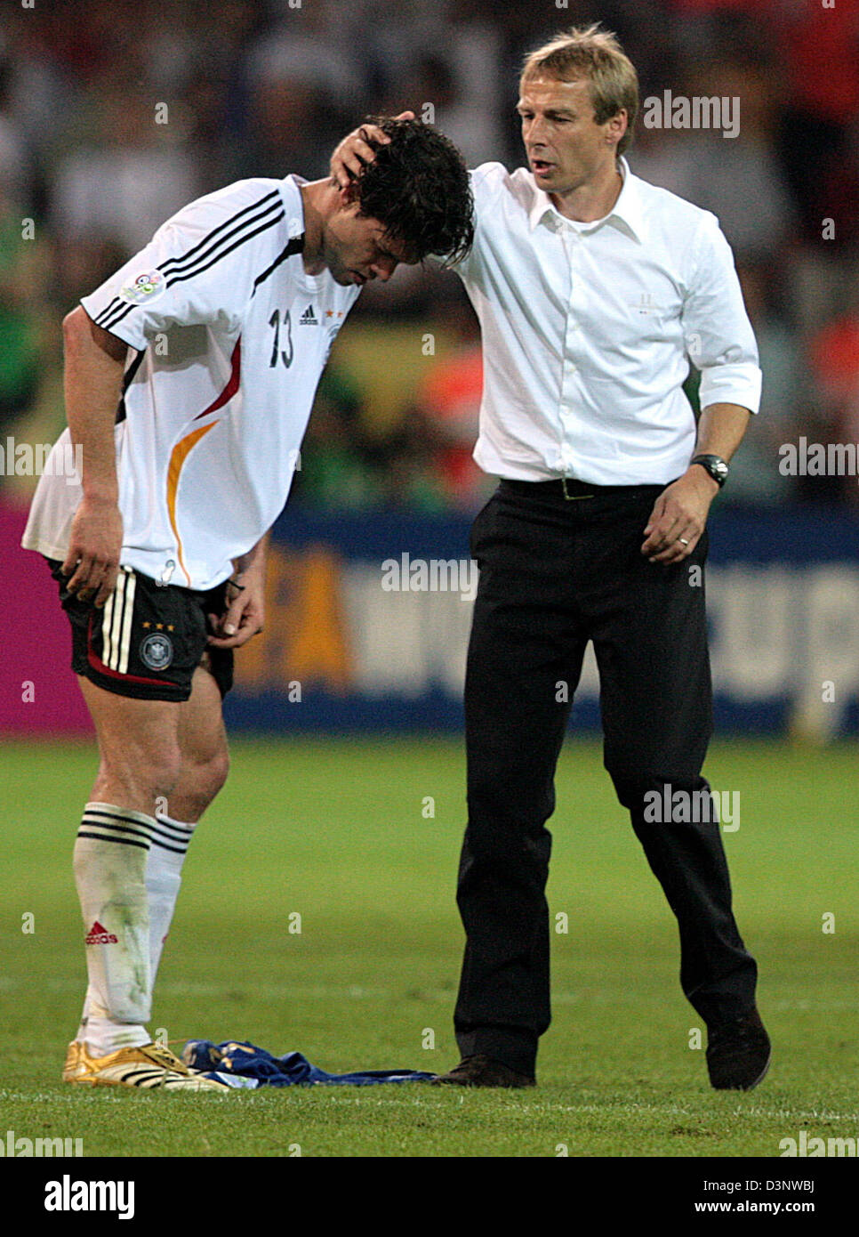 German national coach Juergen Klinsmann (R) consoles Michael Ballack (L ...