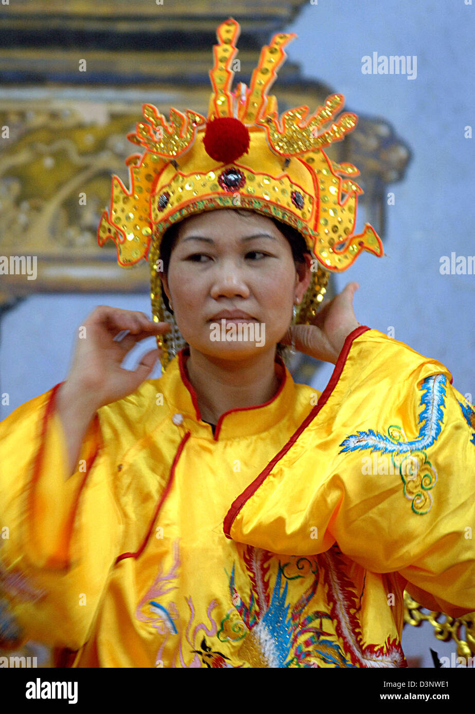 A female visitor poses with a costume of the Nguyen-Dynasty at the ...