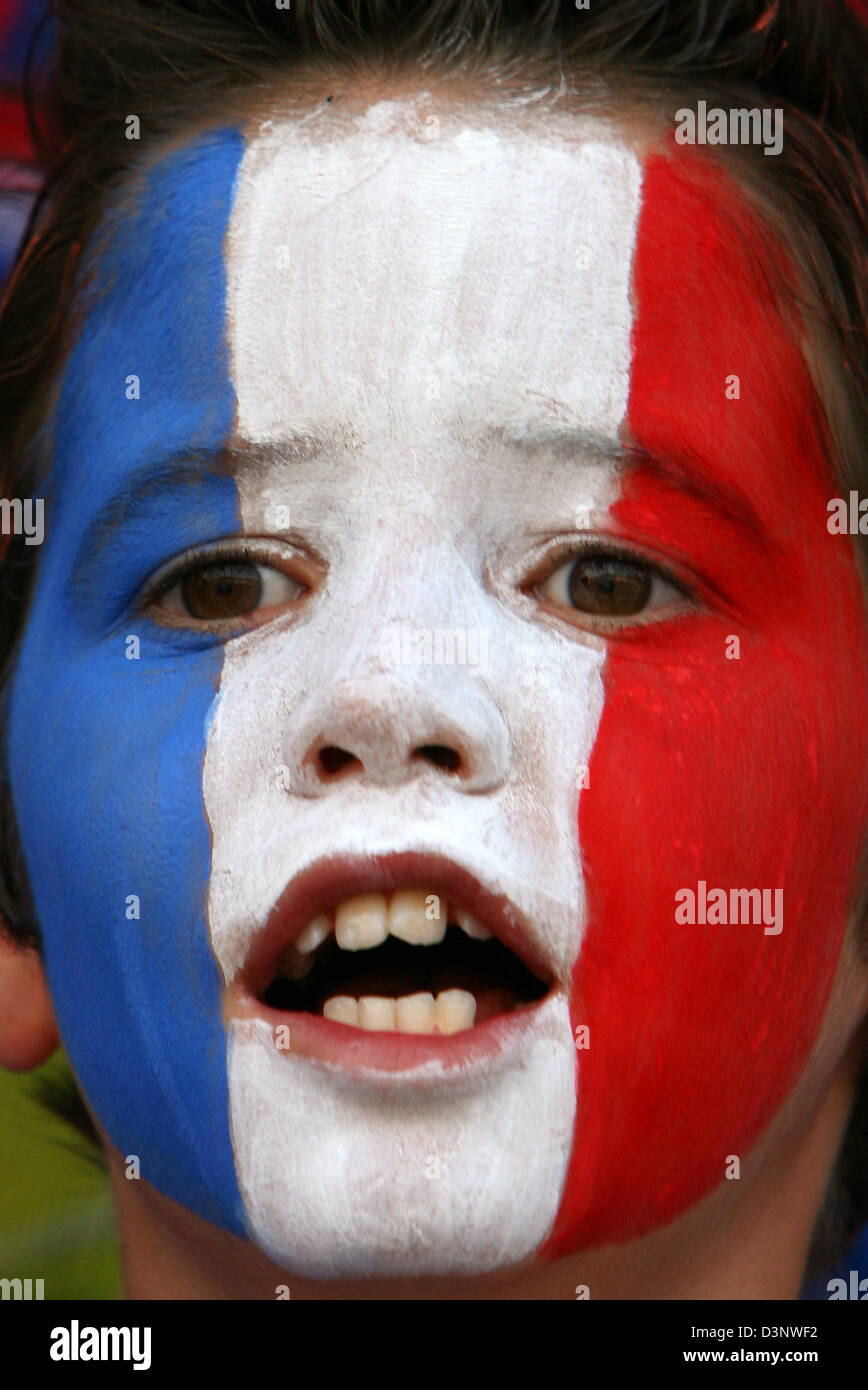 Little French supporter, with his face painted in national colors ...