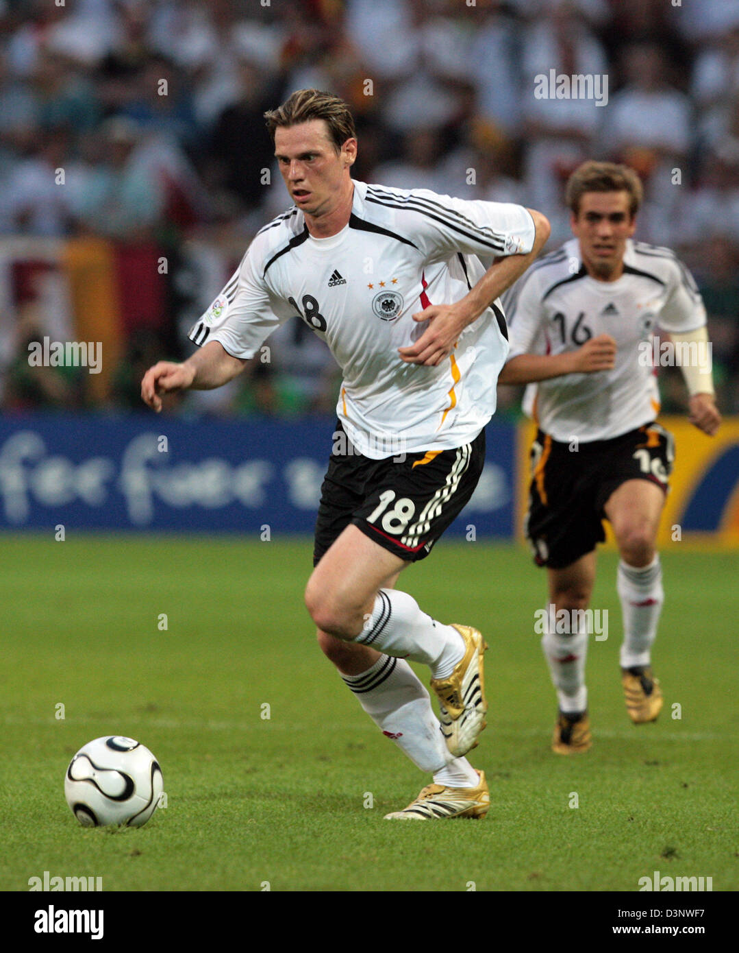 German Tim Borowski plays the ball while team member Philipp Lahm runs ...