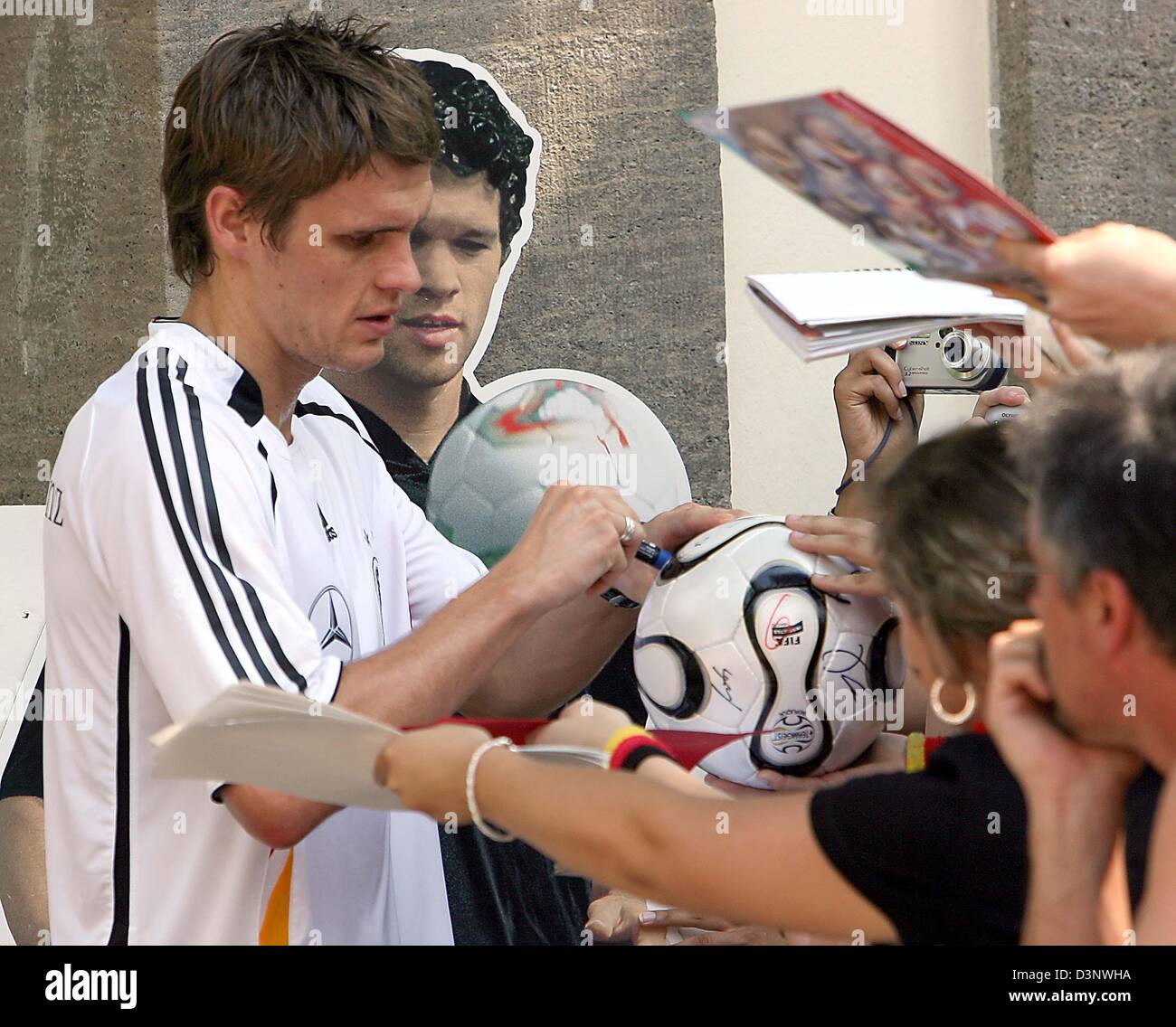 German soccer player Sebastian Kehl (L) signs autographs at the team ...