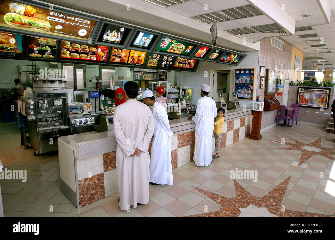 Customers stand in front of the counter of a McDonald's restaurant in ...