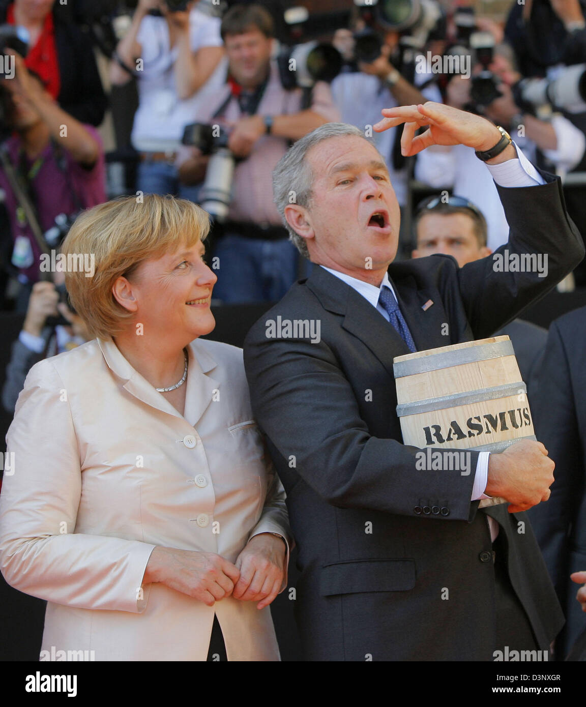 US President George W. Bush gestures with a herring barrel in his arm ...