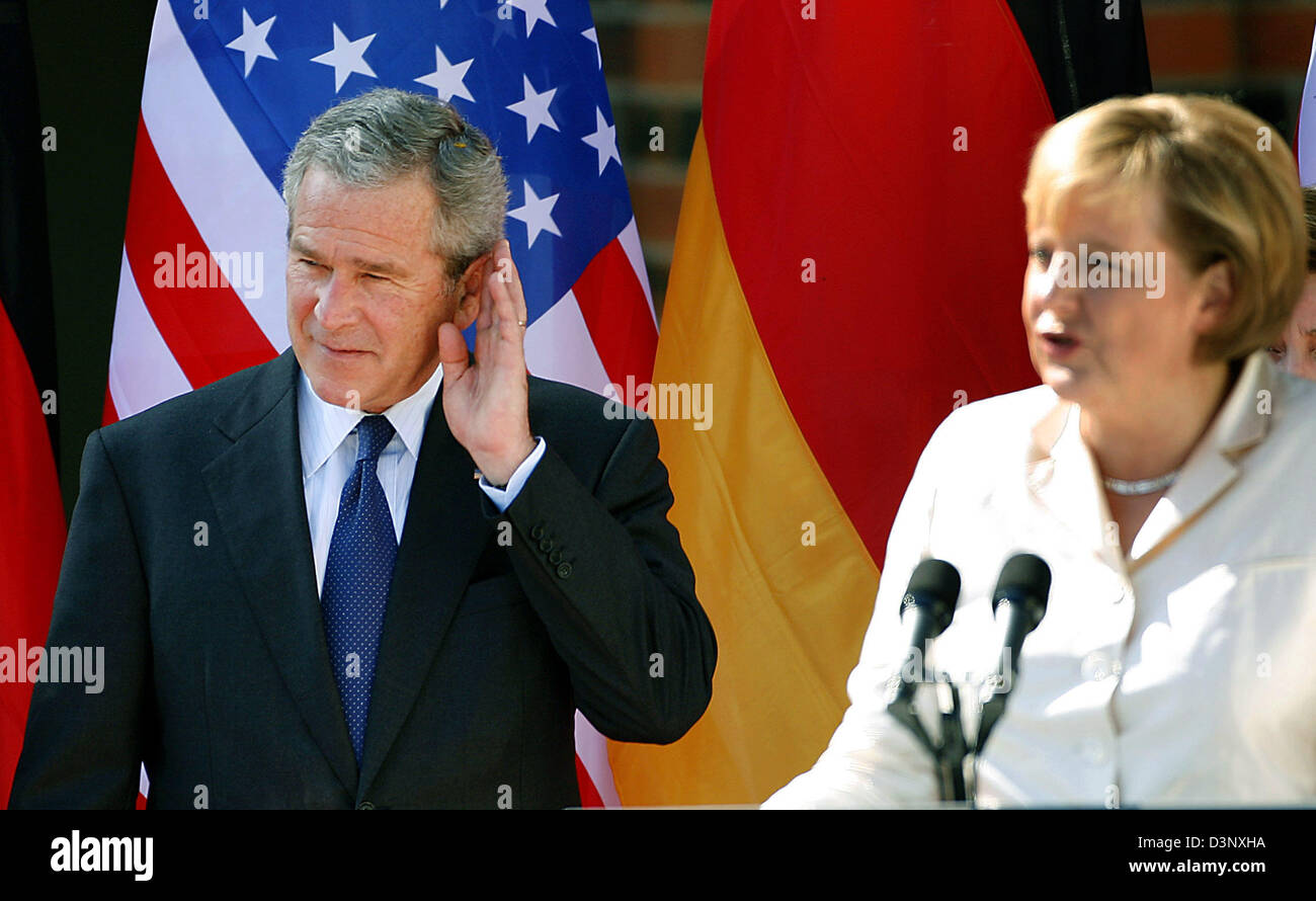 US President George W. Bush touches his ear while German Chancellor ...