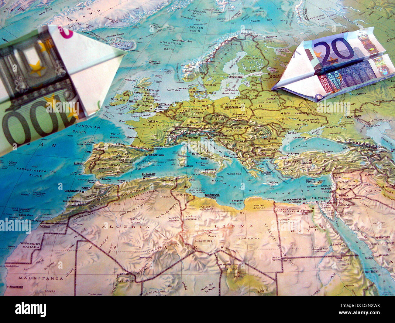 (dpa file) - Euro banknotes folded to paper planes and placed on a map ...