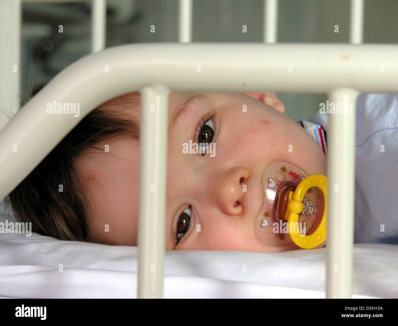 A baby photographed in a cot at a hospital in Esslingen, Germany ...