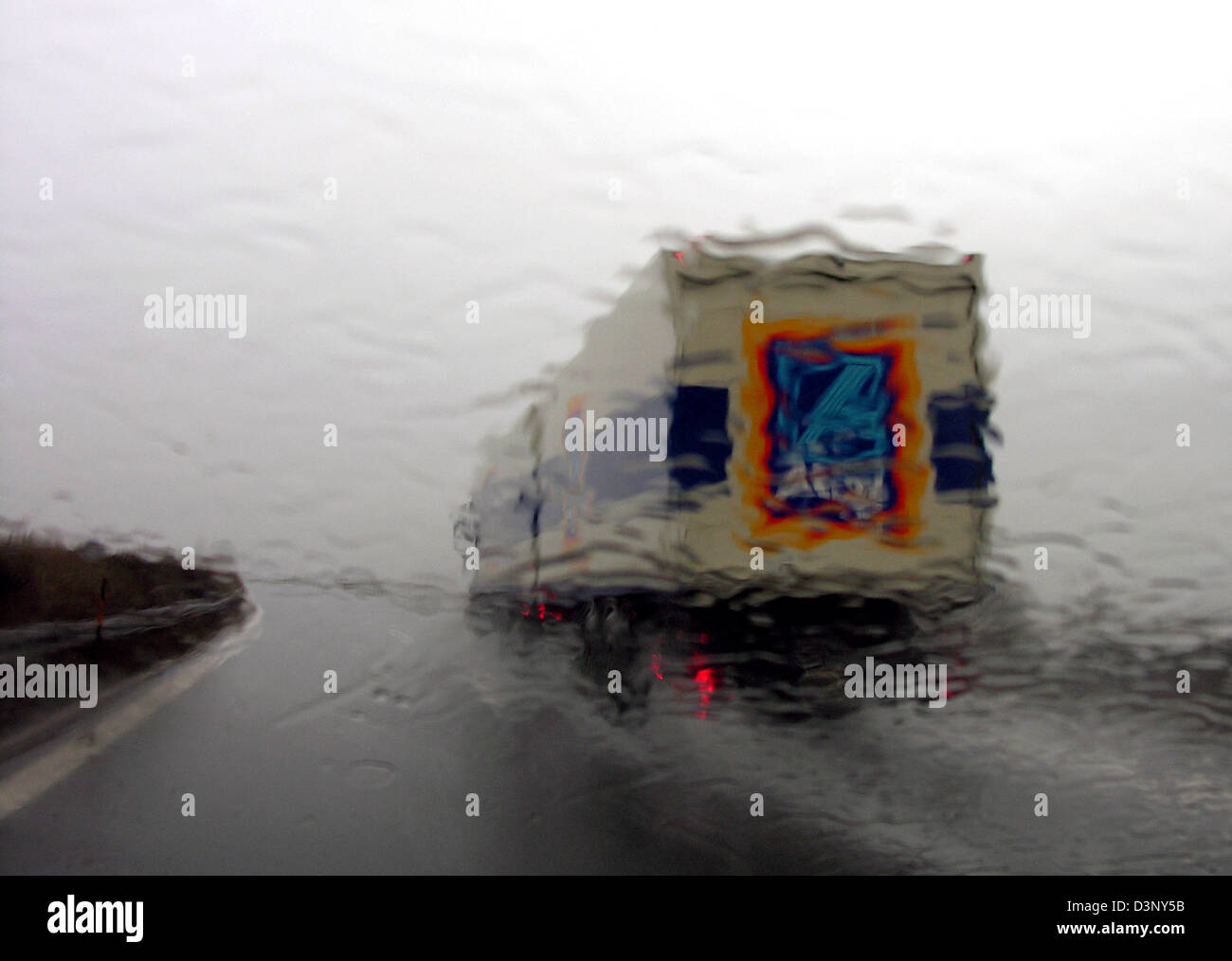 The photo shwos a lorry from behind photographed through the windscreen ...