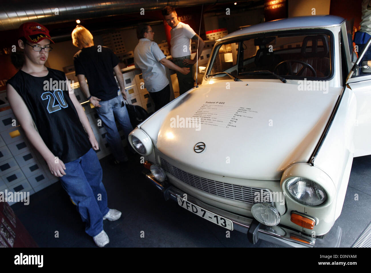 A young visitor examines a typical GDR car called 'Trabant' at the ...