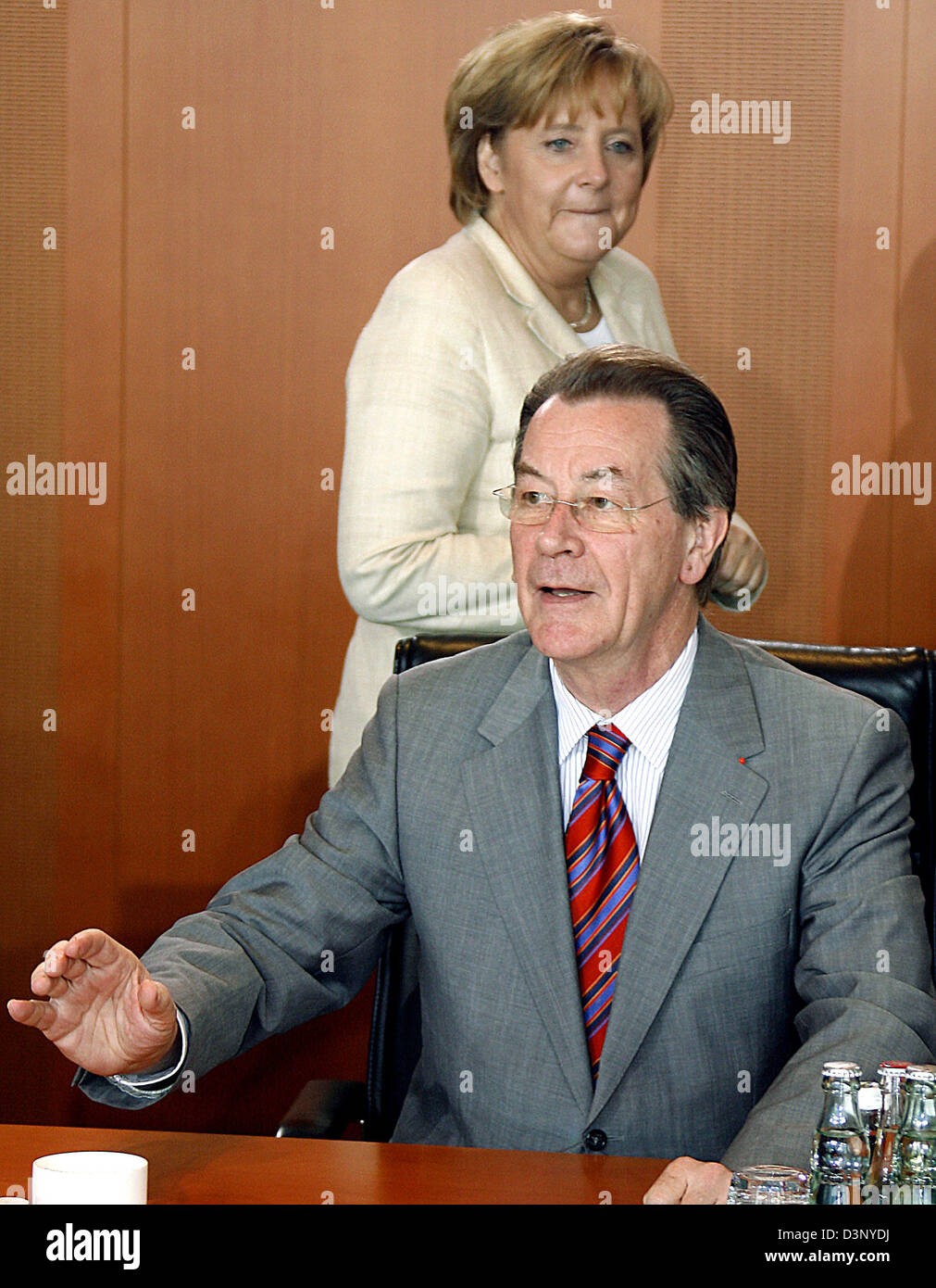 German Chancellor Angela Merkel takes her place next to Minister for ...