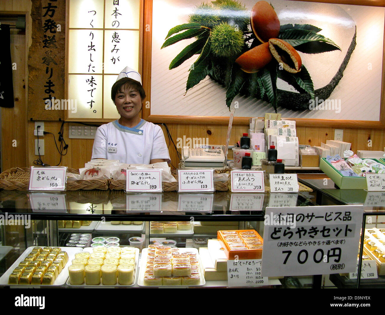 A salesperson photographed behind the counter at a store for pastries ...