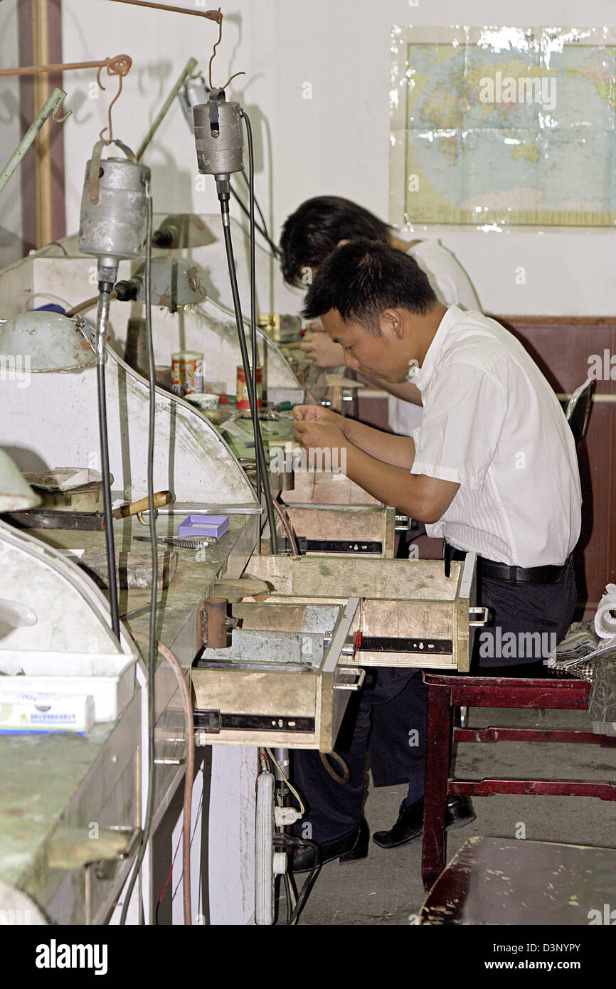 Two workers gives the mineral Jade the right shape with the help of a ...