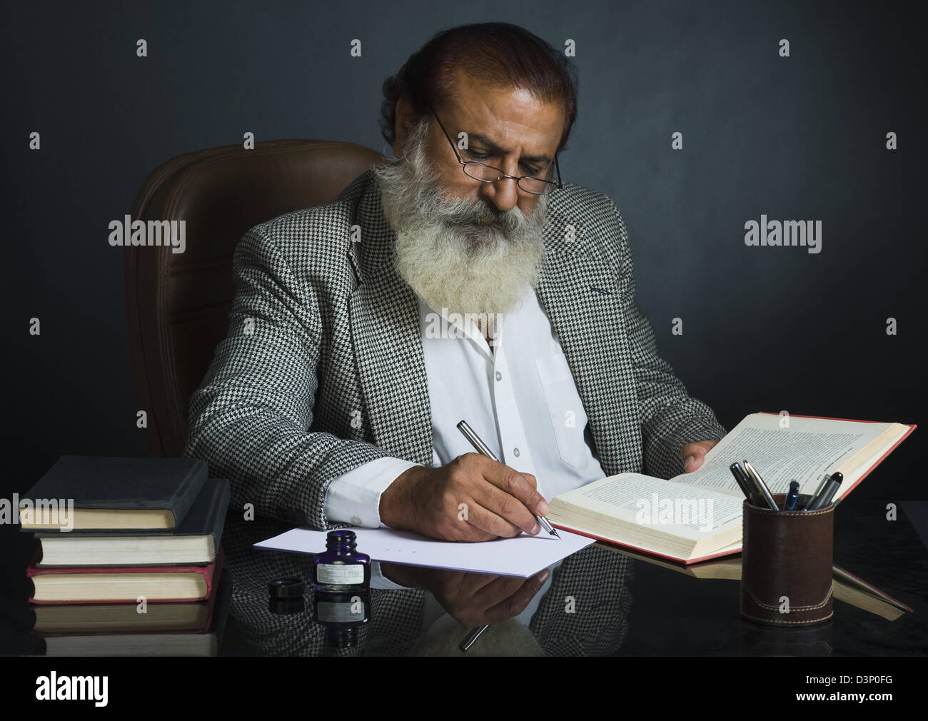 Critic writing review on a book Stock Photo - Alamy