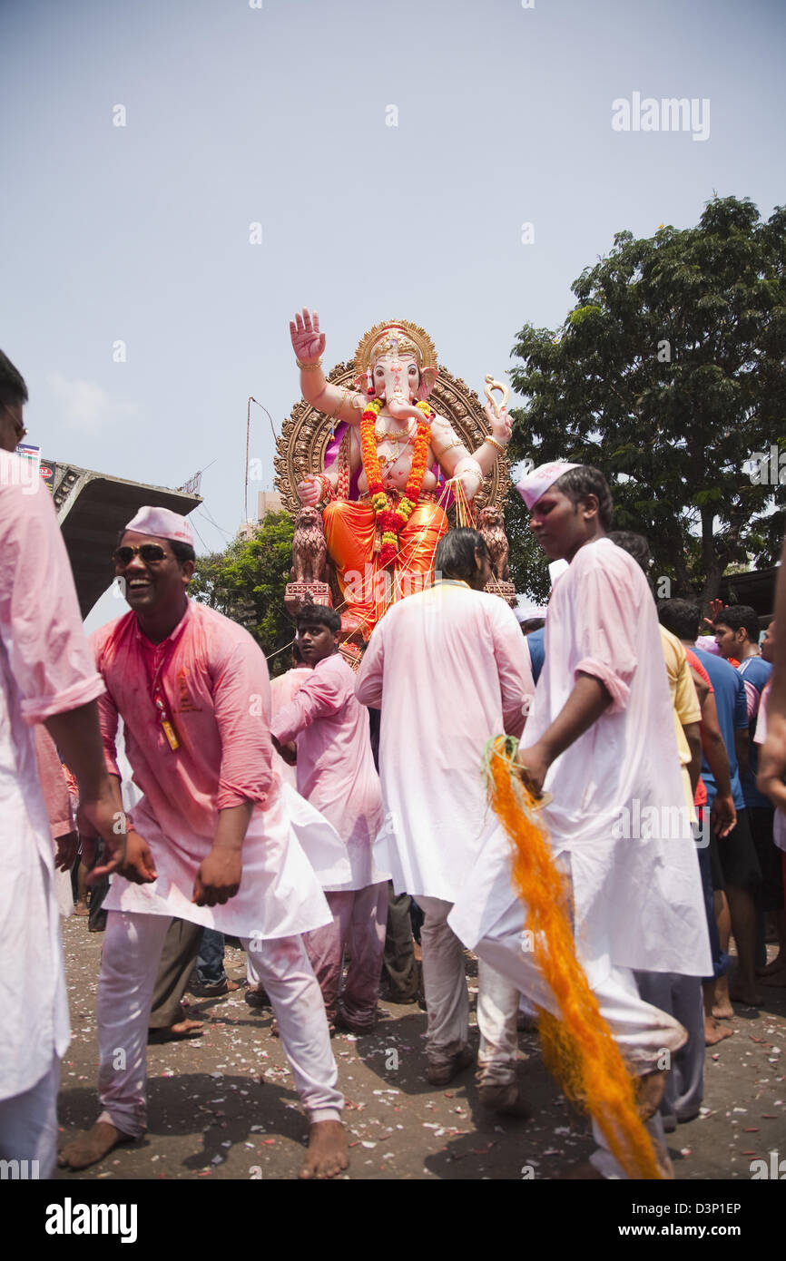 People dancing at religious procession during Ganpati visarjan ceremony ...