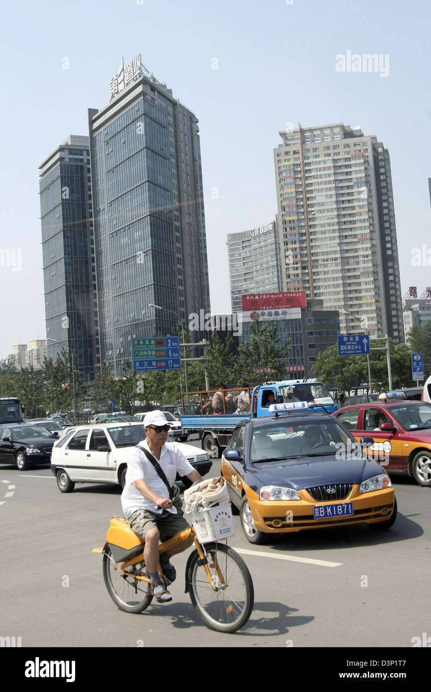 The picture shows a typical street scene with cars and a cyclist in ...