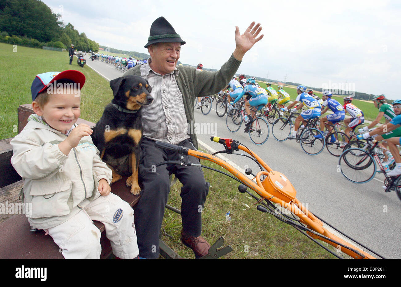 Farmer Paul Wolf and his grandson Alexander shout encouragement to the ...
