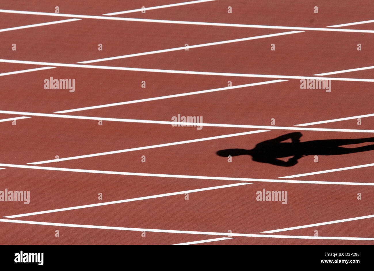 The shadow of a runner is pictured on the cinder tracks at the Ullevi ...