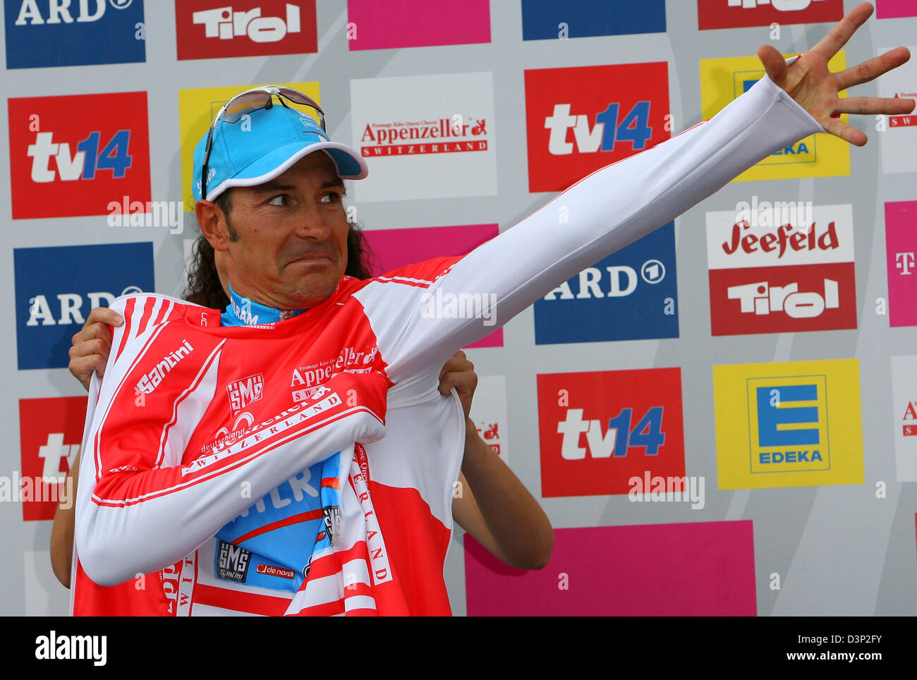 German cycling pro Erik Zabel of the Team Milram puts on the red jersey ...