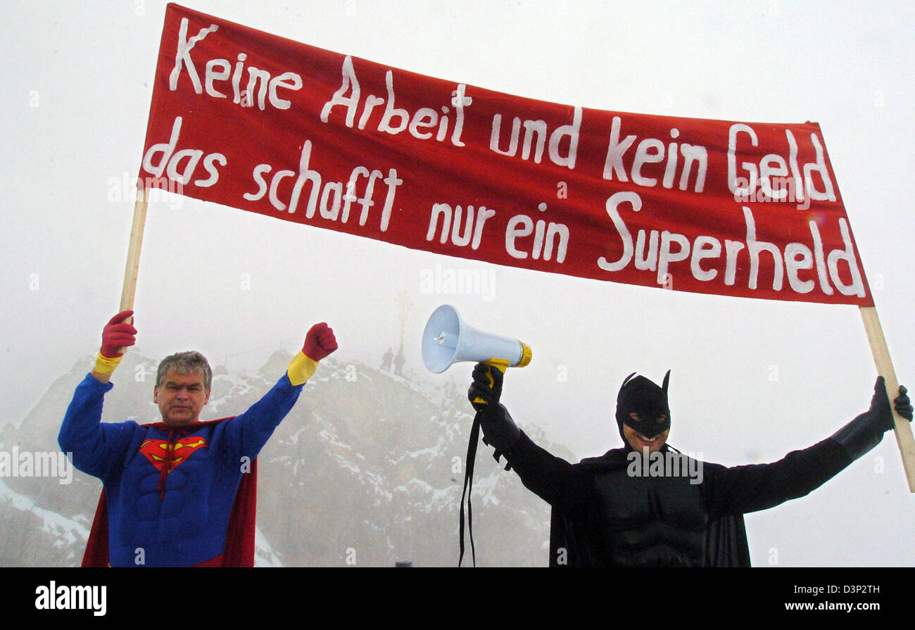 Two unemployed dressed as Superman and Batman protest with a banner ...