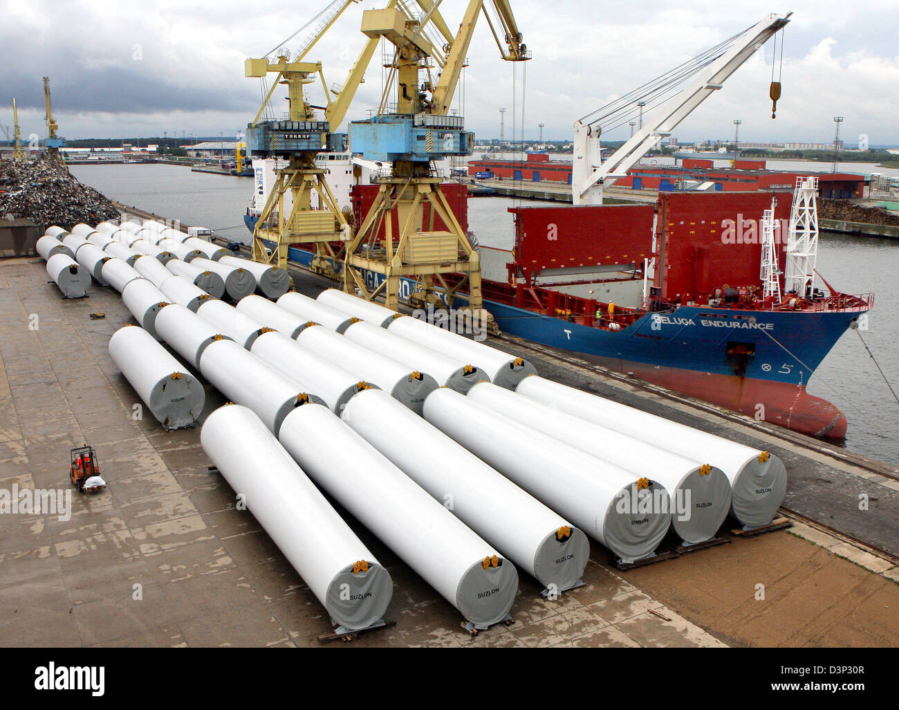 The picture shows segments of windmill towers that are being loaded on ...