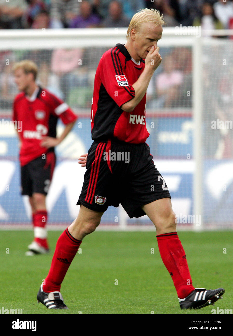 Carsten Ramelow of Leverkusen leaves the pitch after receiving the ...